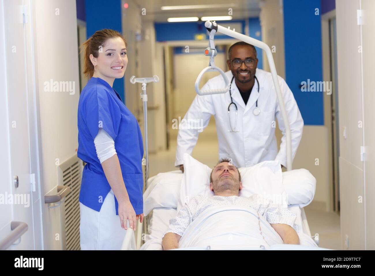 patient hospital bed moved by medical staff to operating room Stock ...