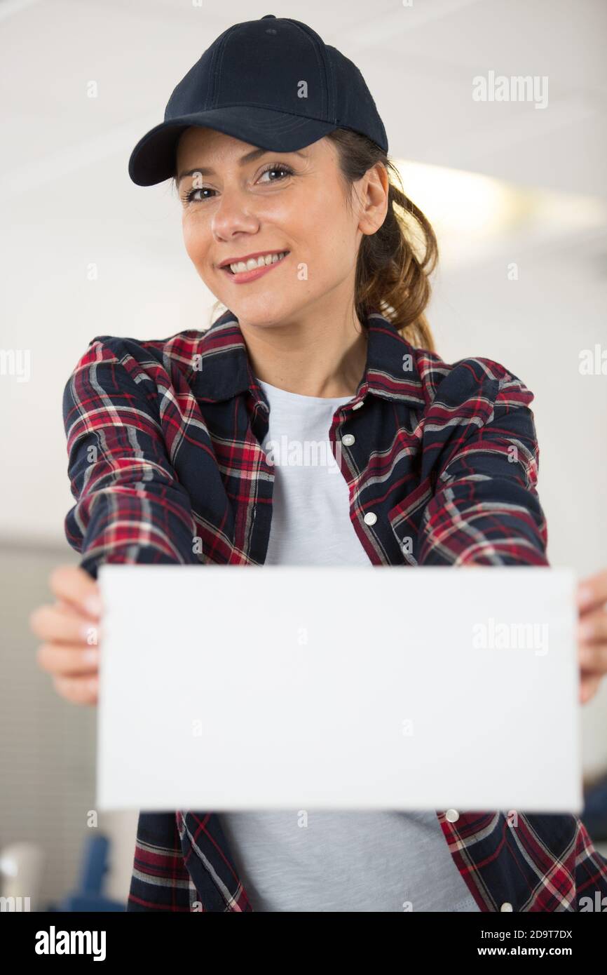 diy woman with white panel for your advert Stock Photo - Alamy