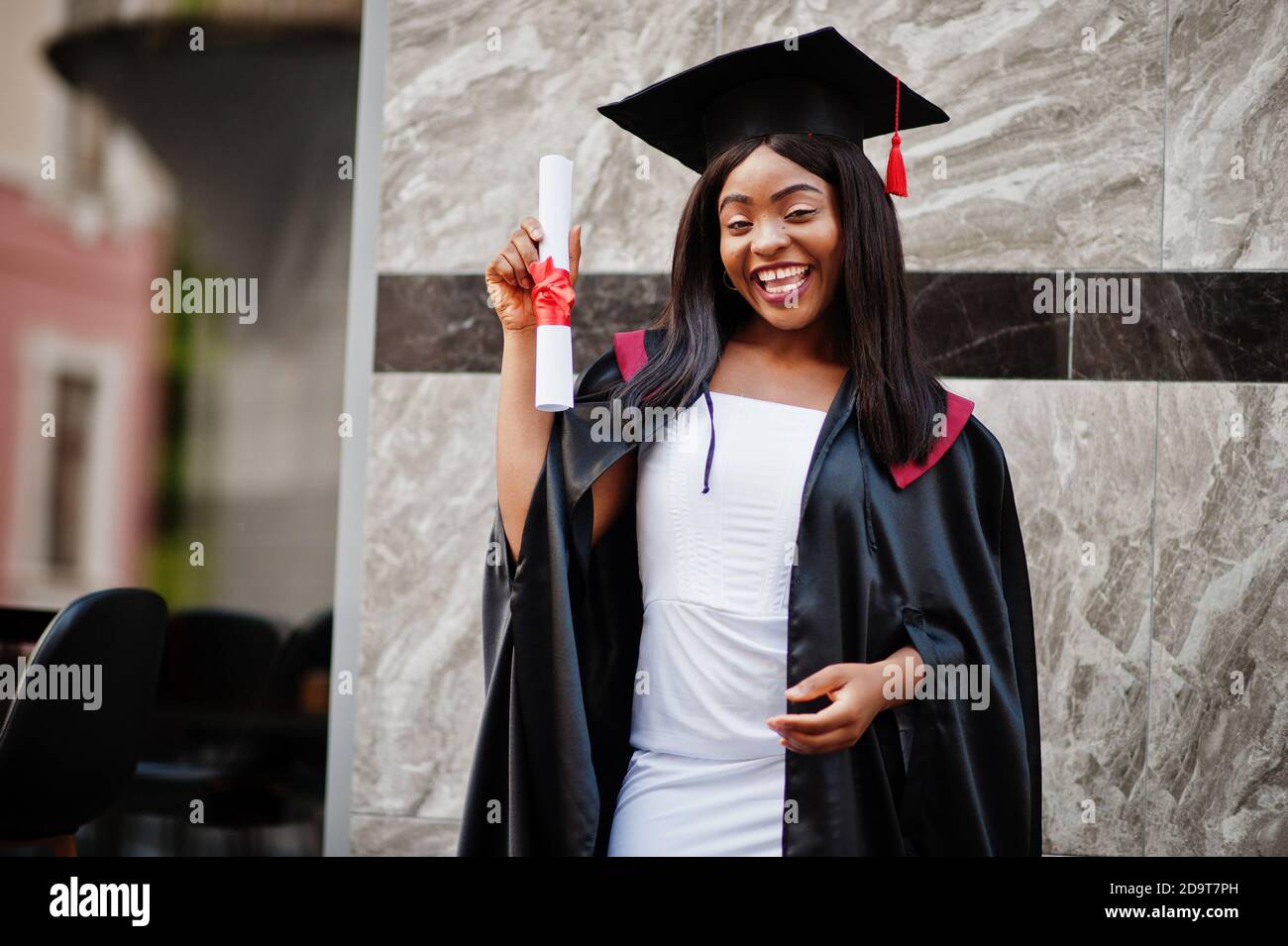 Young female african american student with diploma poses outdoors Stock ...