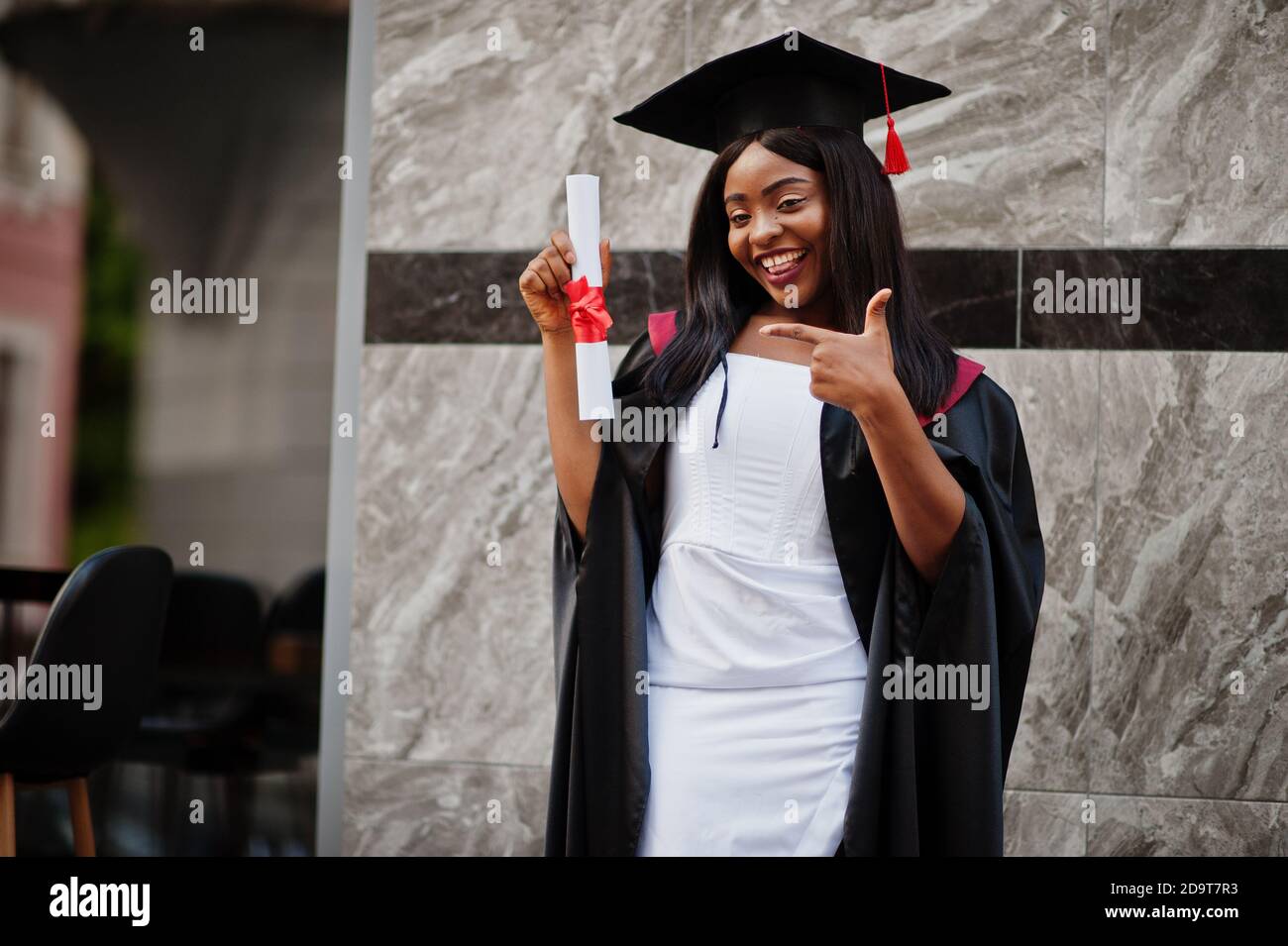 Young female african american student with diploma poses outdoors Stock ...