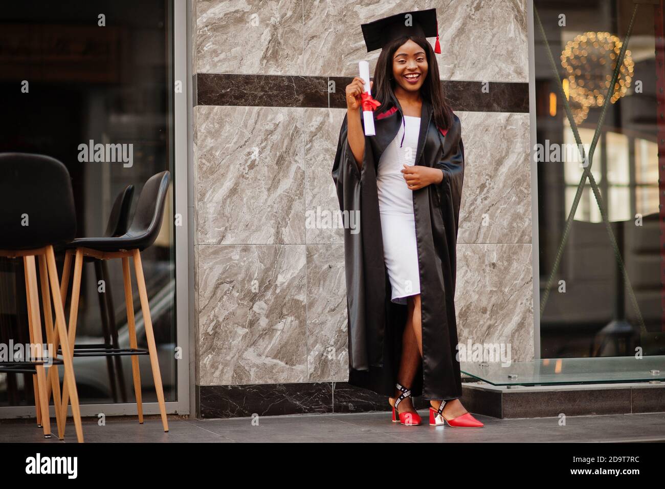 Young female african american student with diploma poses outdoors Stock ...
