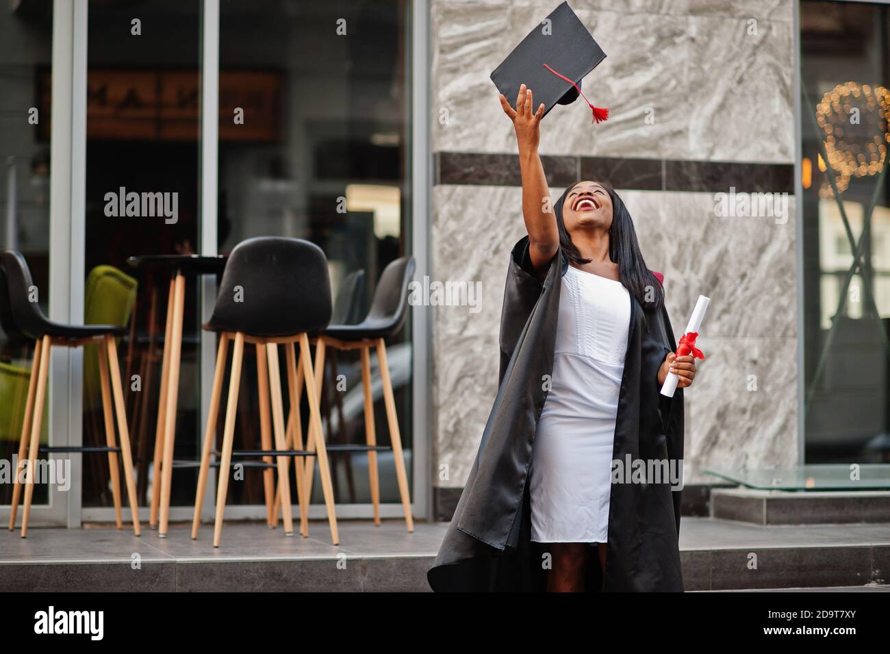 Young female african american student with diploma poses outdoors Stock ...