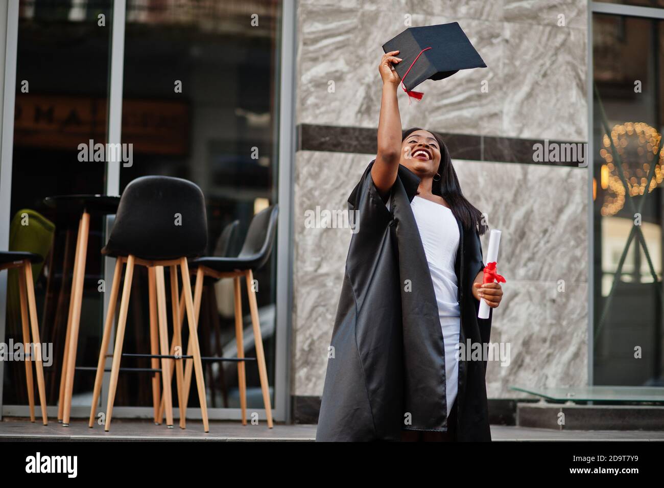 Young female african american student with diploma poses outdoors Stock ...