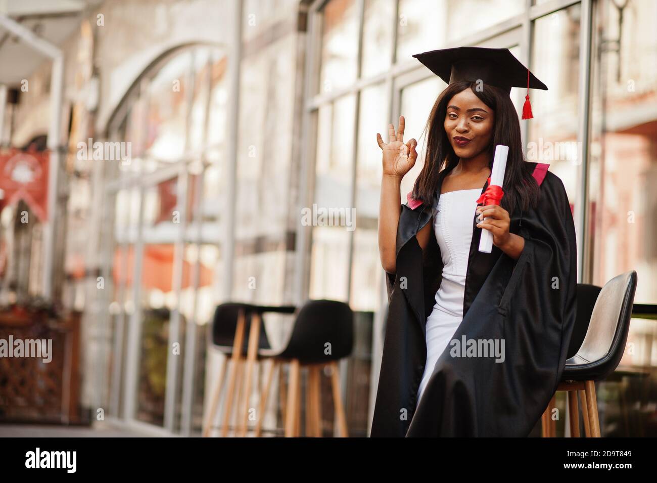 Young female african american student with diploma poses outdoors Stock ...