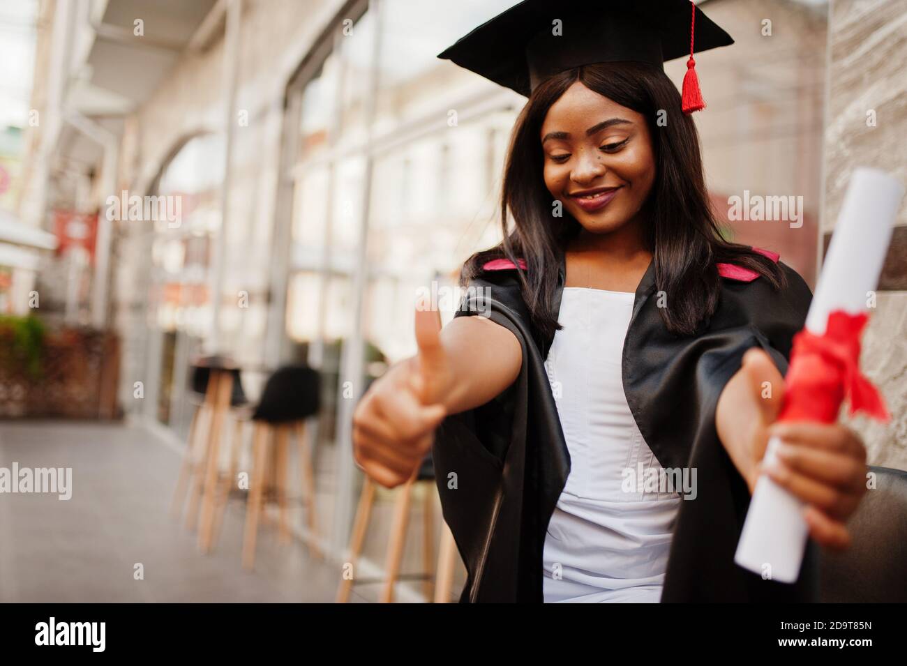 Young female african american student with diploma poses outdoors Stock ...