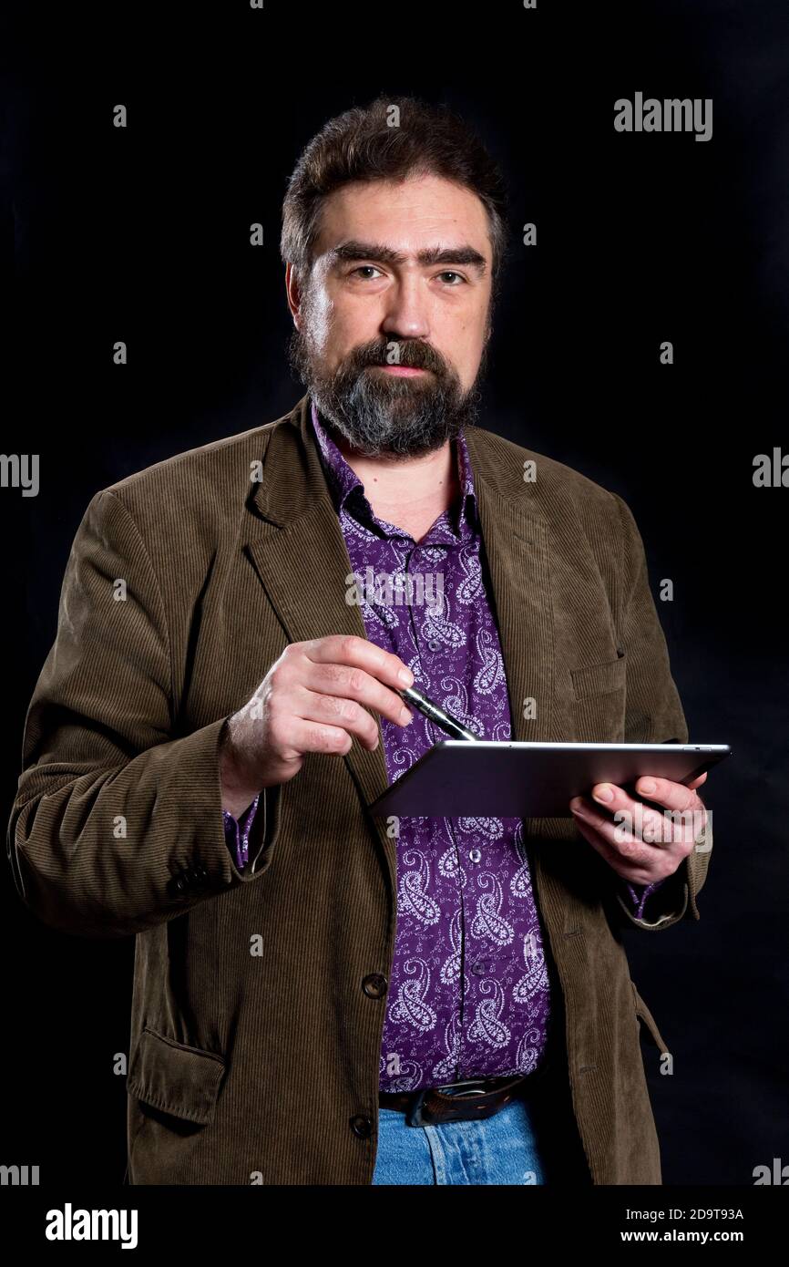 Business trainer dressed in casual emotional studio portrait on black ...