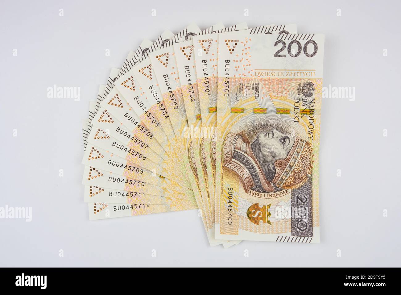 Top view of lots of 200 zloty bills isolated on a white background ...