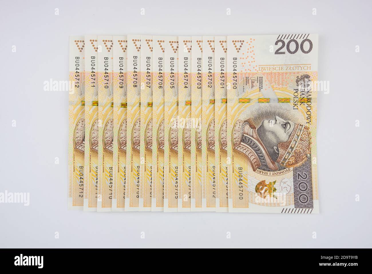 Top view of lots of 200 zloty bills isolated on a white background ...