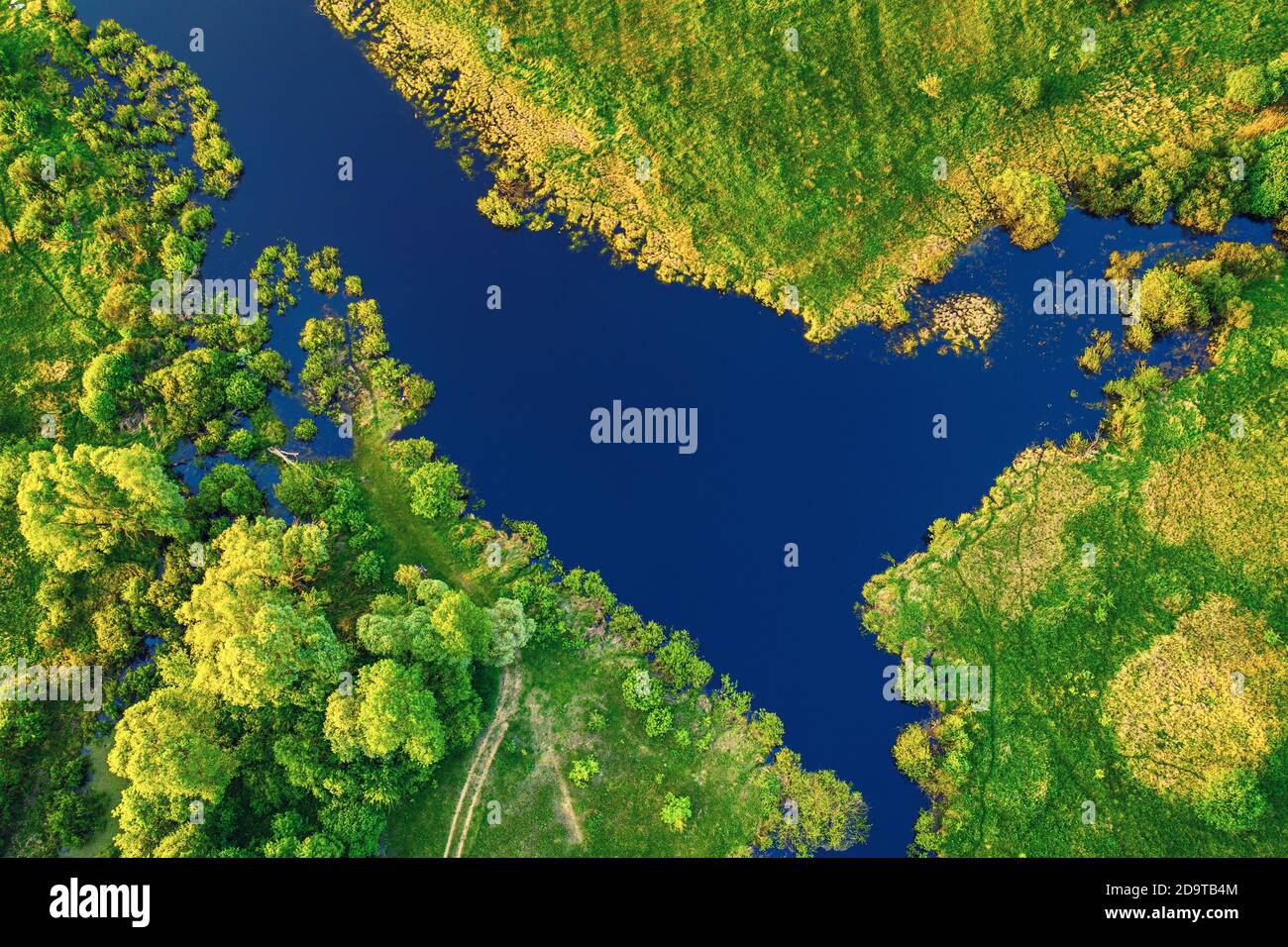 Aerial landscape of blue lake in green field, top view of beautiful ...