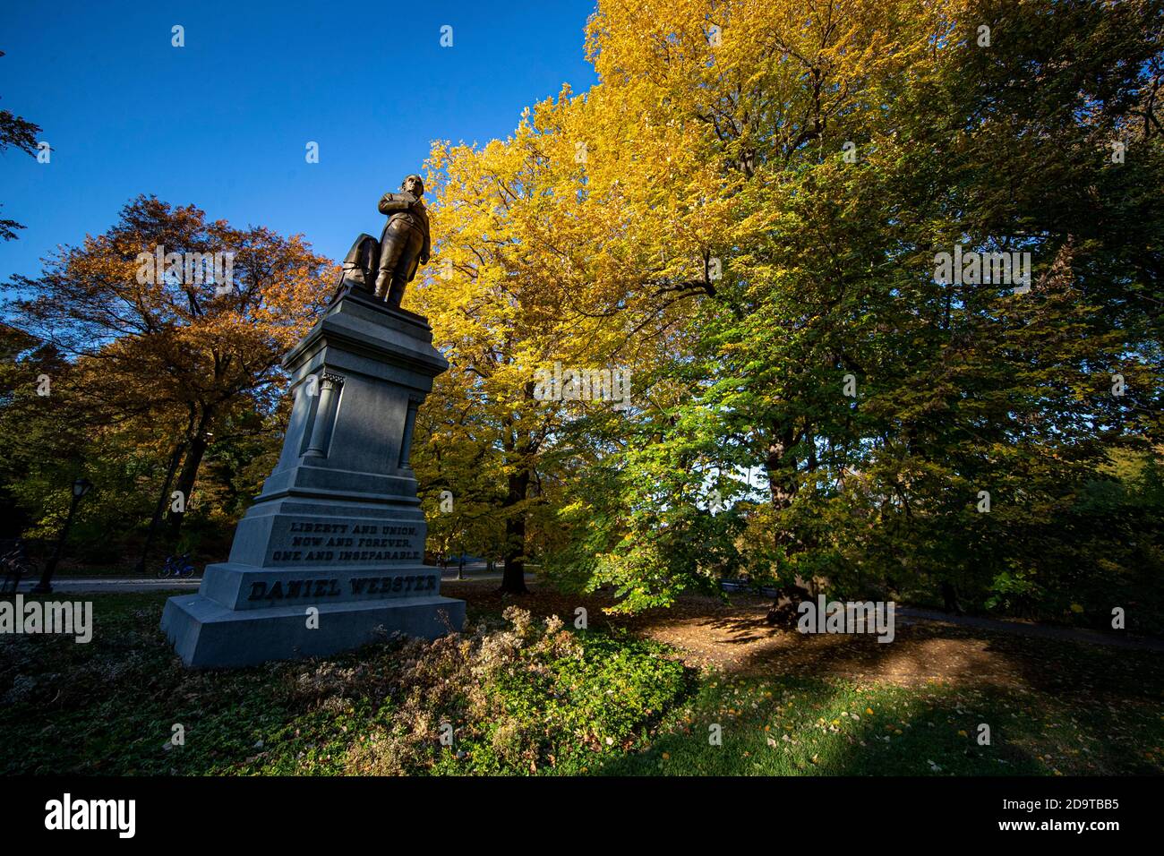 An outdoor bronze sculpture of Daniel Webster is surrounded by the ...