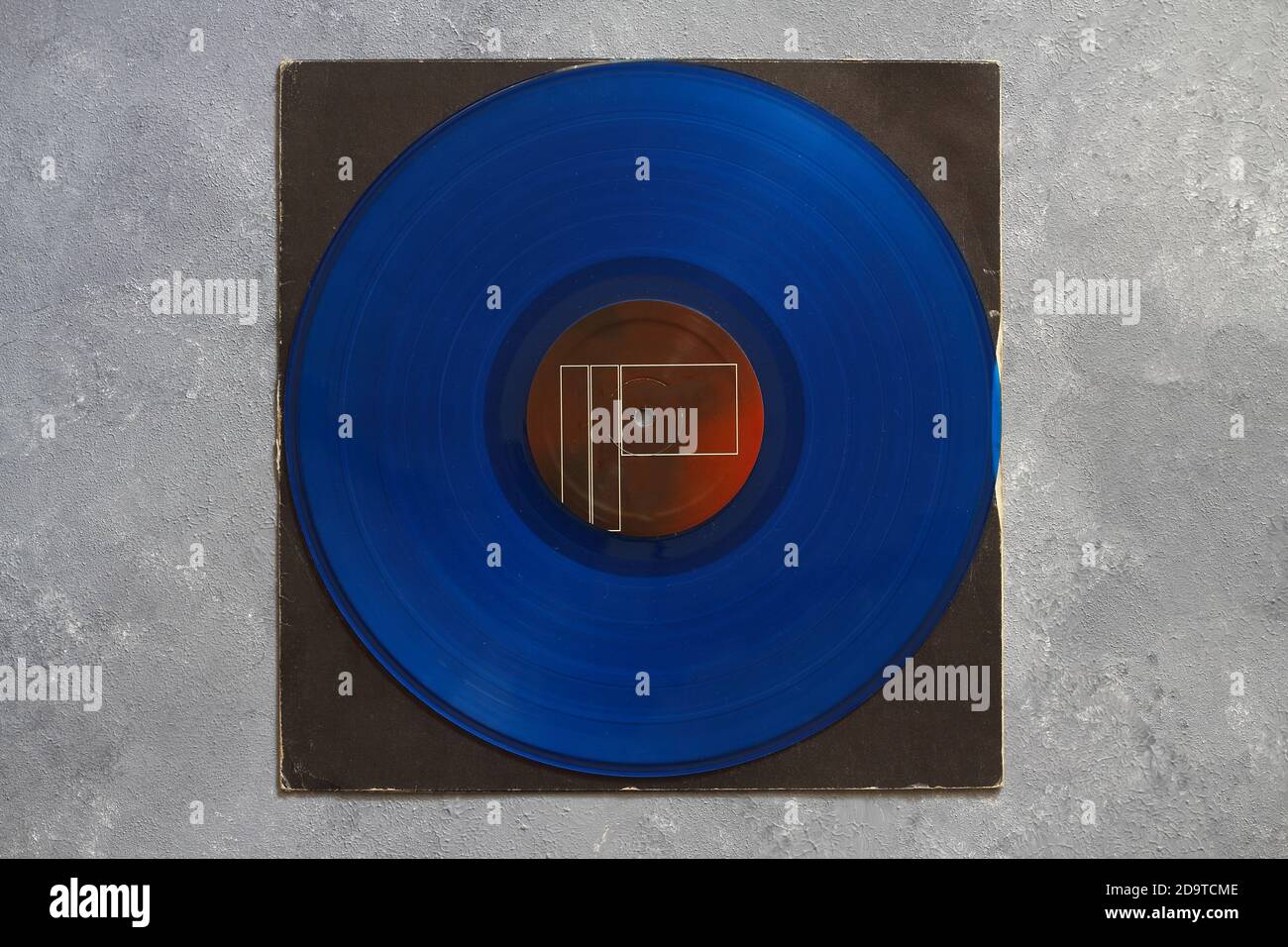Aged black paper cover and blue vinyl LP record isolated on stone ...