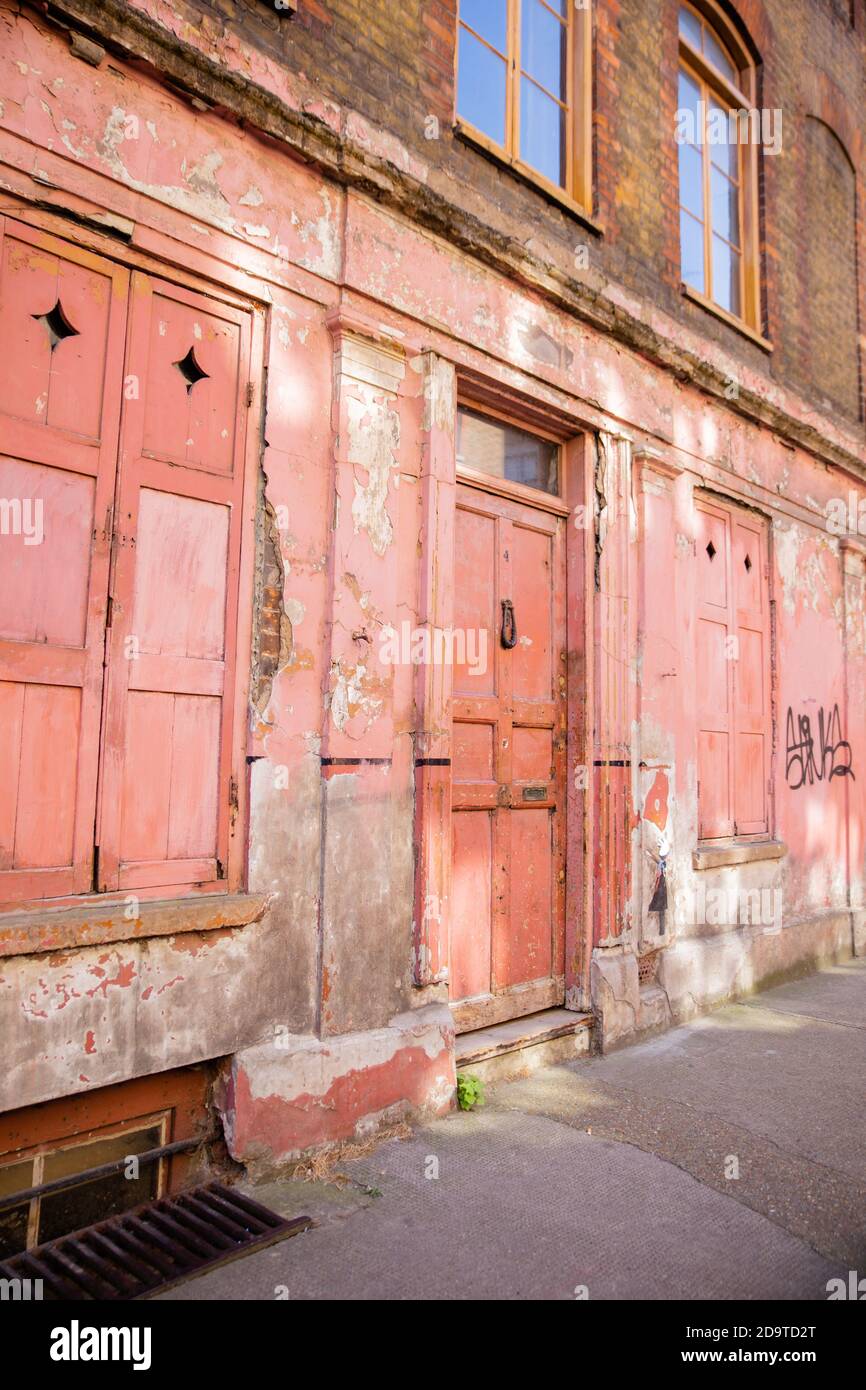 Portrait View of the Door and Windows of a Deteriorated Red Building ...