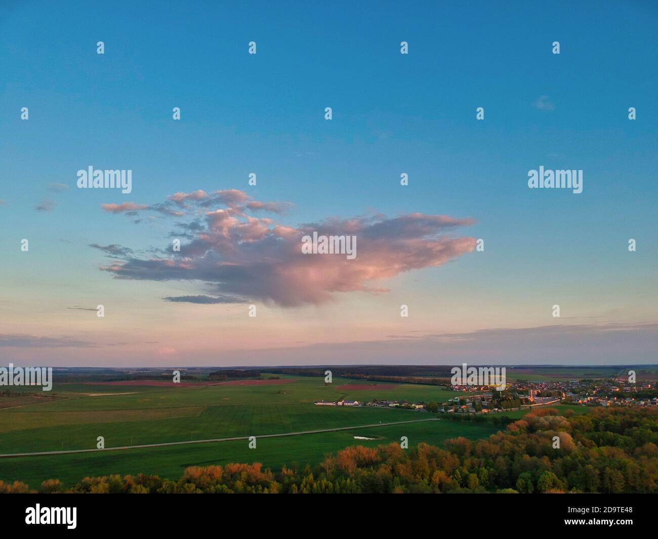Aerial shot of a beautiful plain on a sunset sky background with a ...