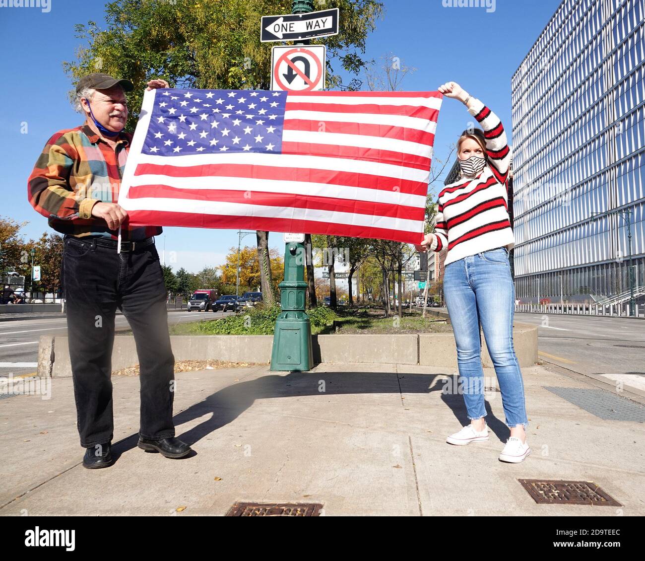 Manhattan, New York, USA. 7th Nov, 2020. Two people hold the America ...