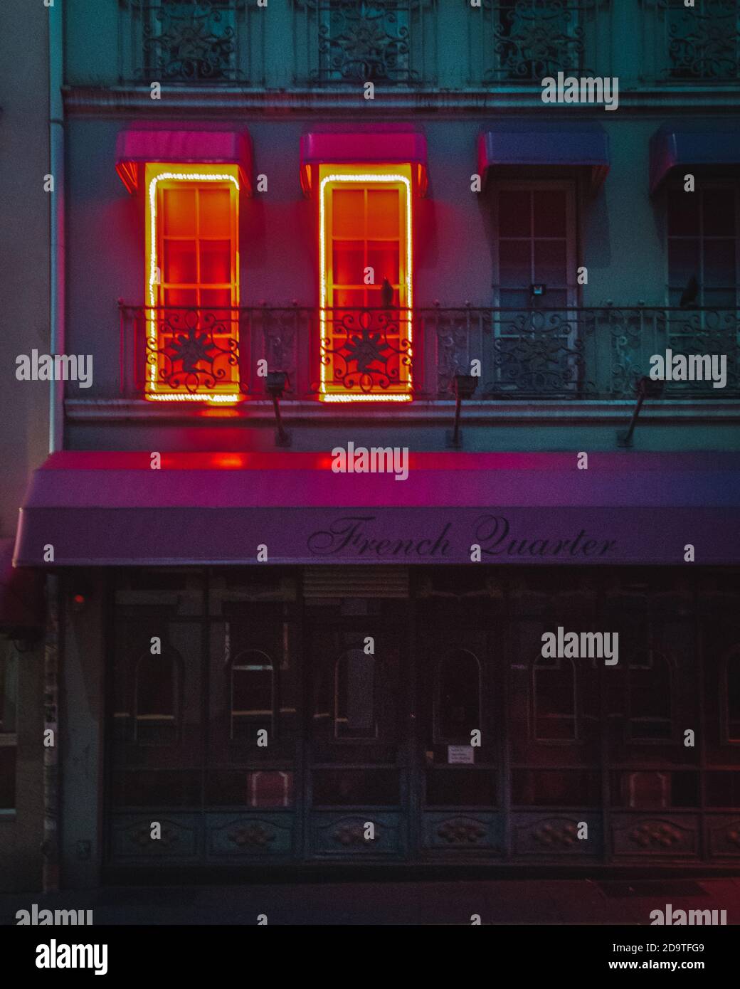 Neon sign fluorescent red being lit windows of French Quarter Hamburg ...