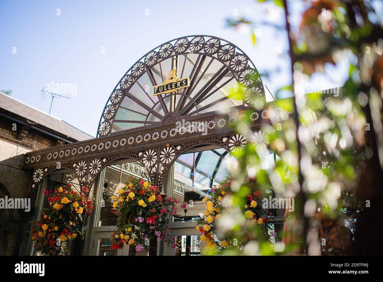 Glass and Metal Arch Over a Cafe Entrance Surrounded by Flowers Stock ...
