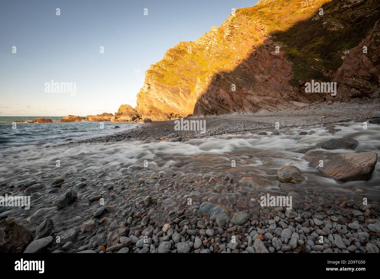 Long exposure of the river Heddon flowing onto the beach at Heddons ...