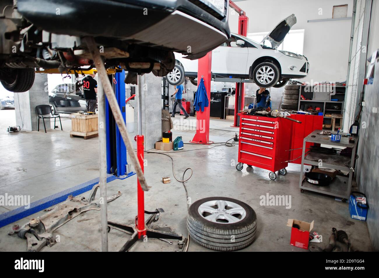 Cars lifting in maintenance at garage service station Stock Photo - Alamy