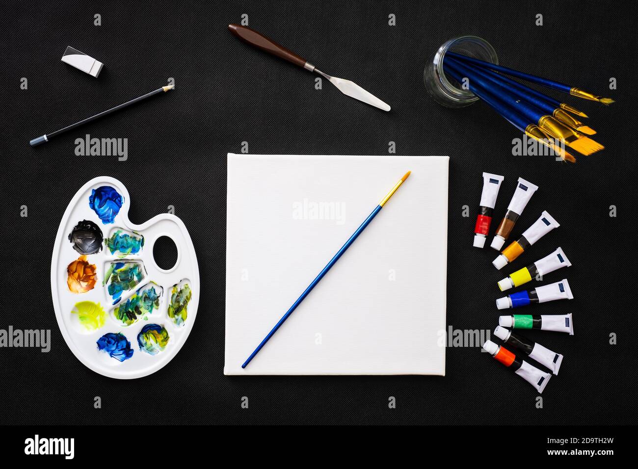 Simple set of tools and colors for painting on canvas Stock Photo - Alamy