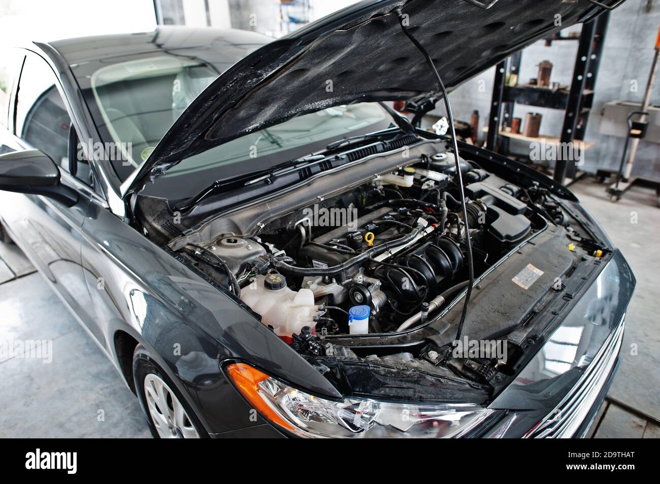 Car repair and maintenance theme. Car open hood engine in auto service ...