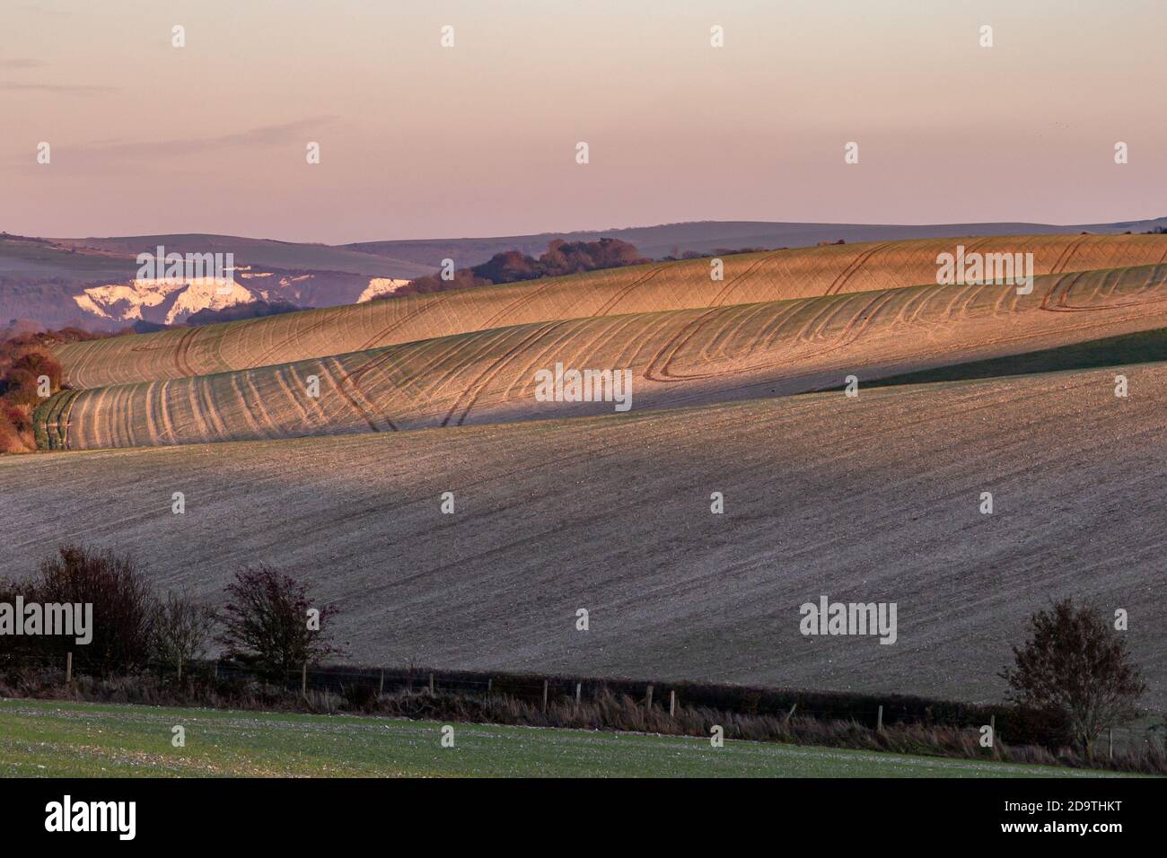 Rolling countryside in the South Downs with the chalk cliffs in Lewes ...