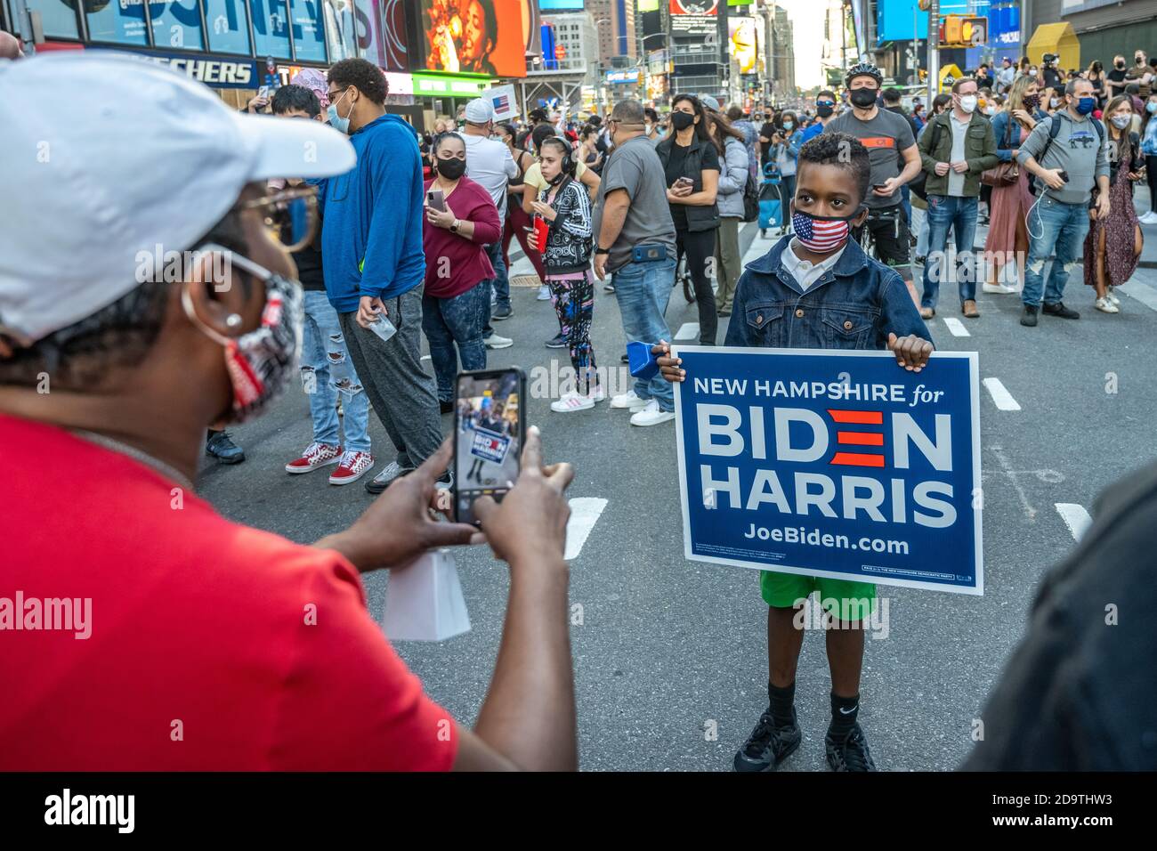 New York, USA. 7th Nov, 2020. People wear face masks as they celebrate ...