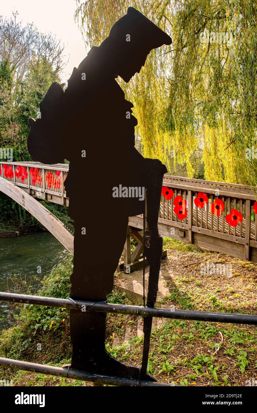 A cast iron silhouette of a soldier with head bowed and a footbridge ...