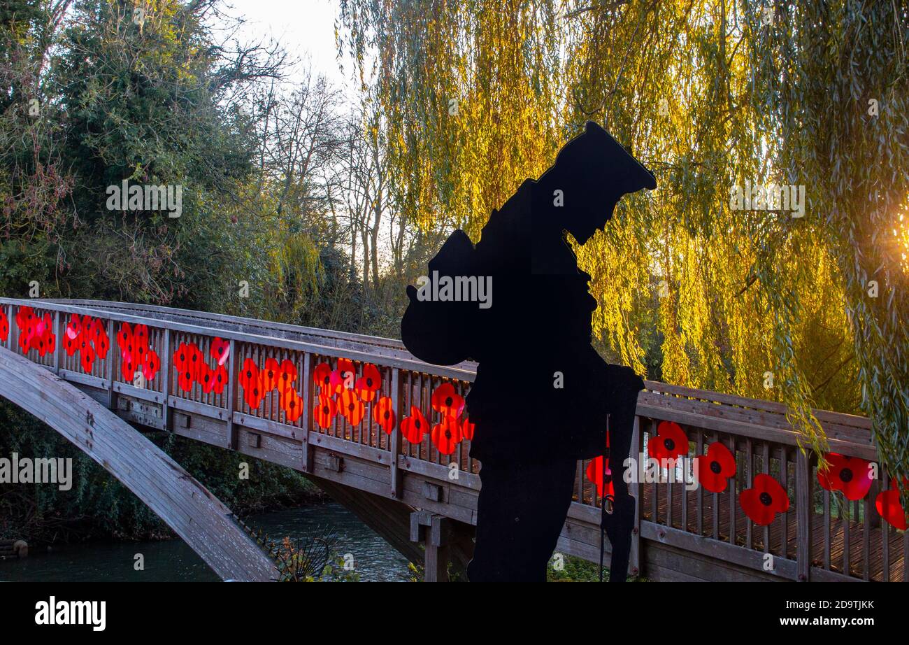 A cast iron silhouette of a soldier with head bowed and a footbridge ...