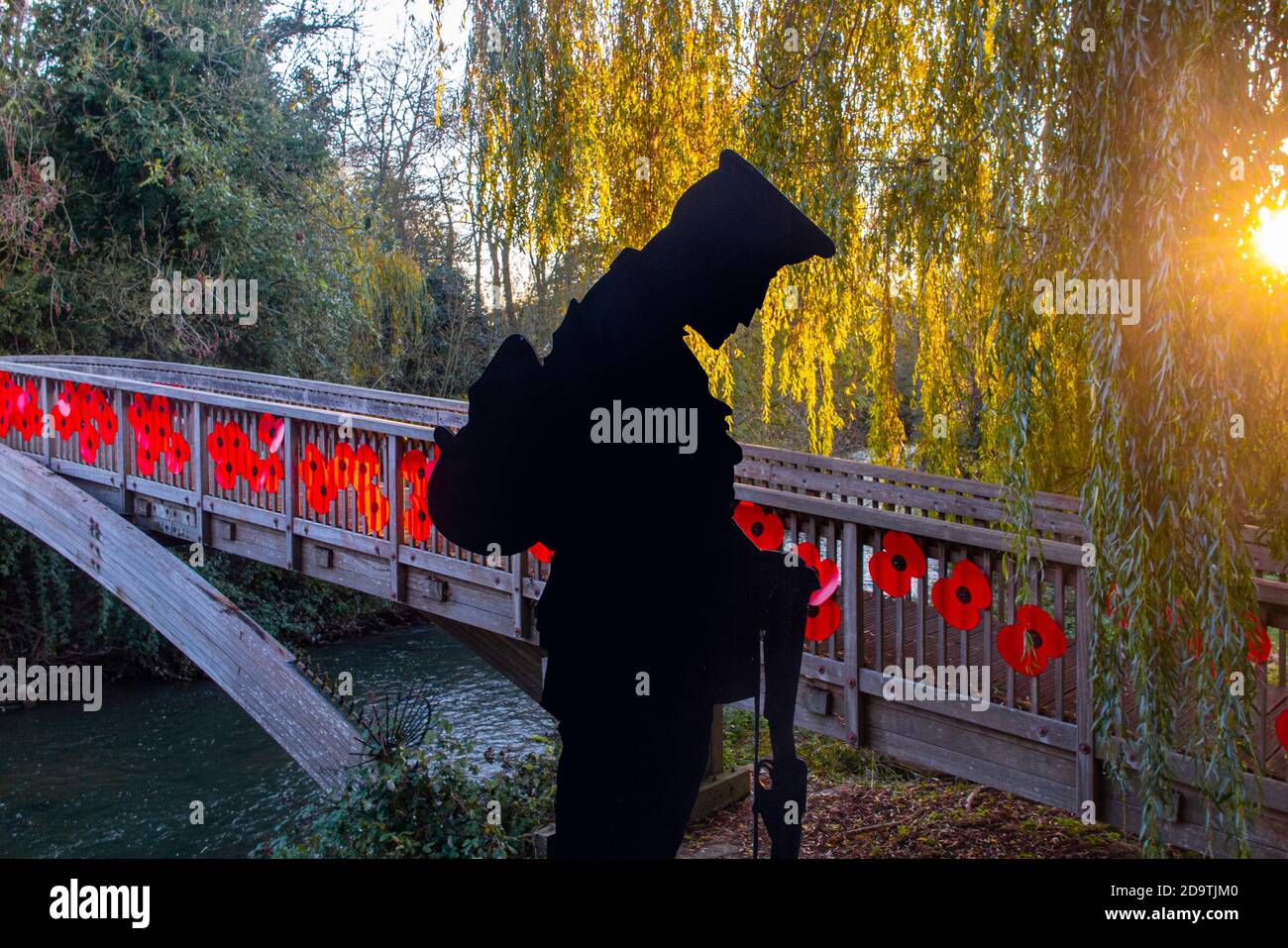 A cast iron silhouette of a soldier with head bowed and a footbridge ...