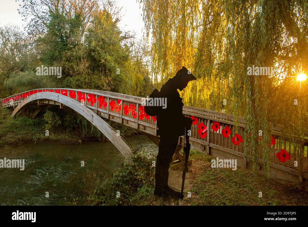 A cast iron silhouette of a soldier with head bowed and a footbridge ...