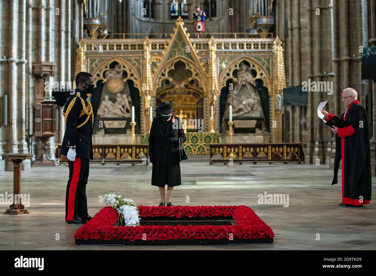 The Dean of Westminster Abbey David Hoyle (right) watches as The Queen ...