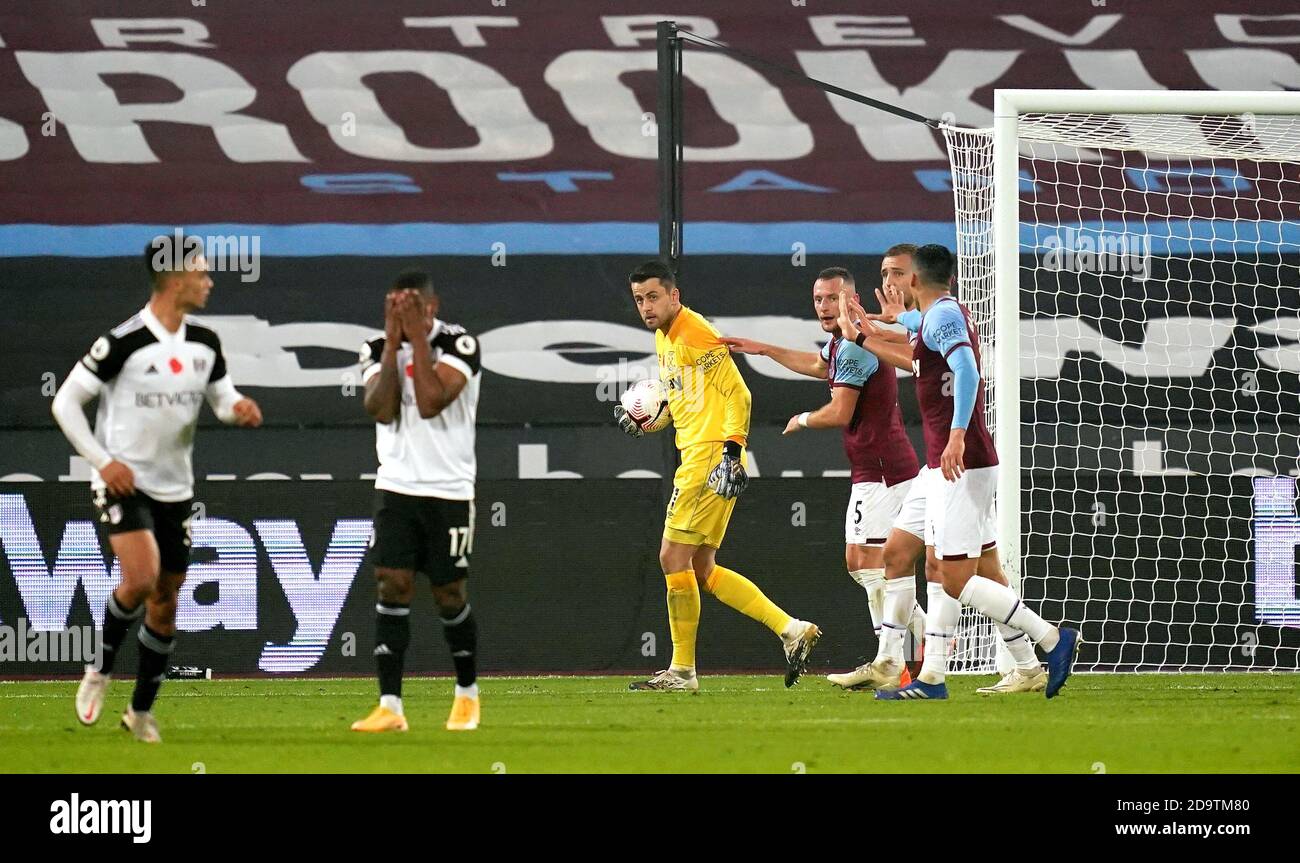 West Ham United goalkeeper Lukasz Fabianski (centre) celebrates saving ...