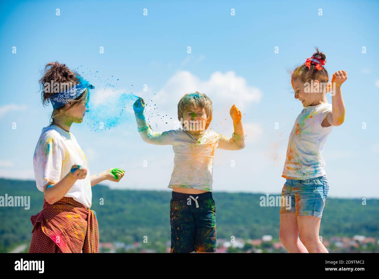 Bright and happy children playing with colored powder Stock Photo - Alamy