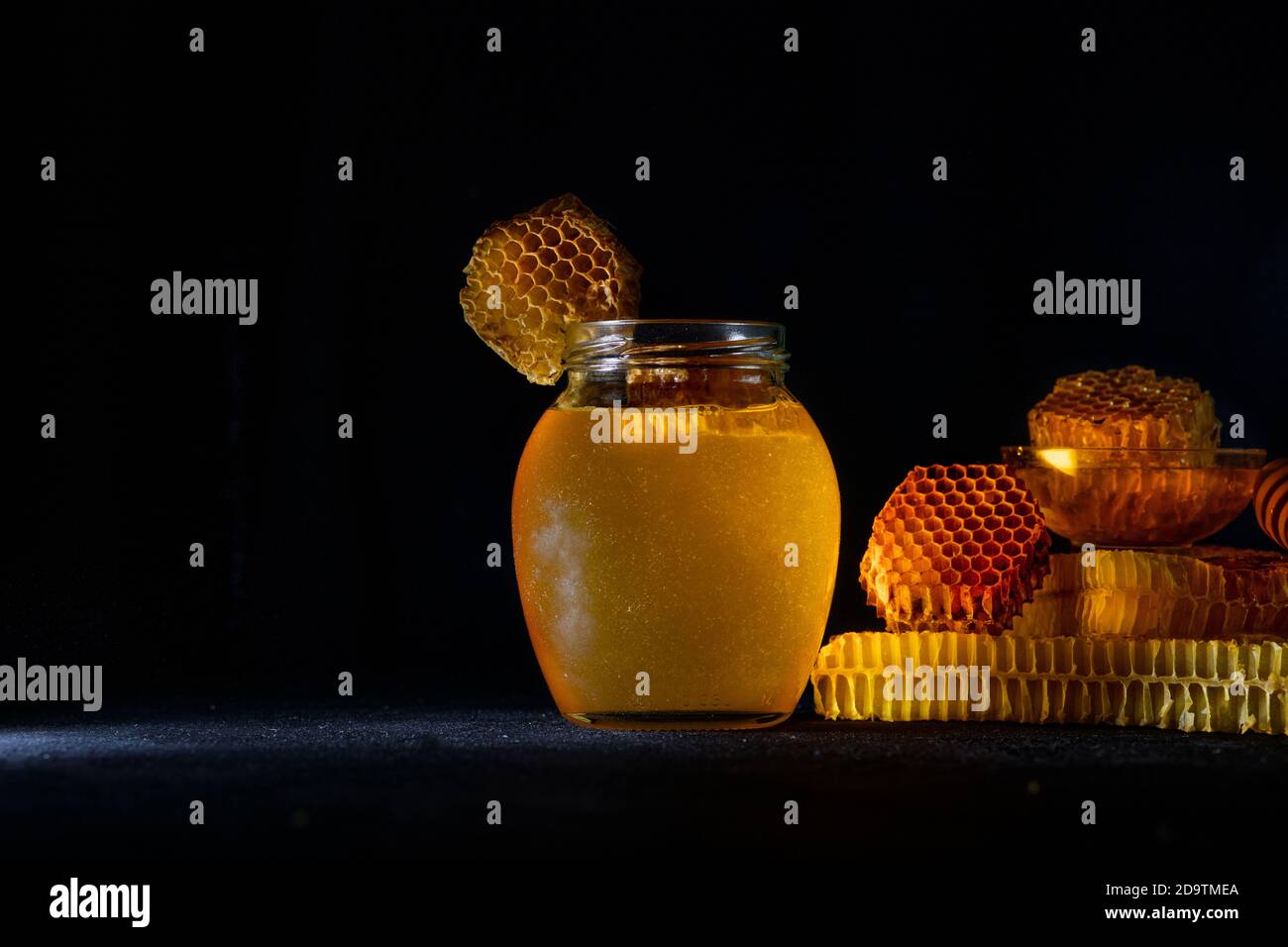 Honey with honeycomb on black table, top view. space for text Stock ...