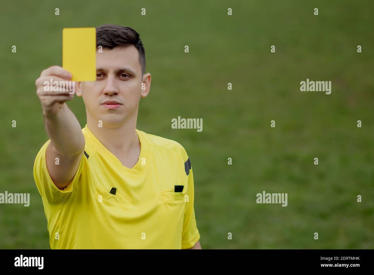 Referee showing a yellow card to a displeased football or soccer player ...