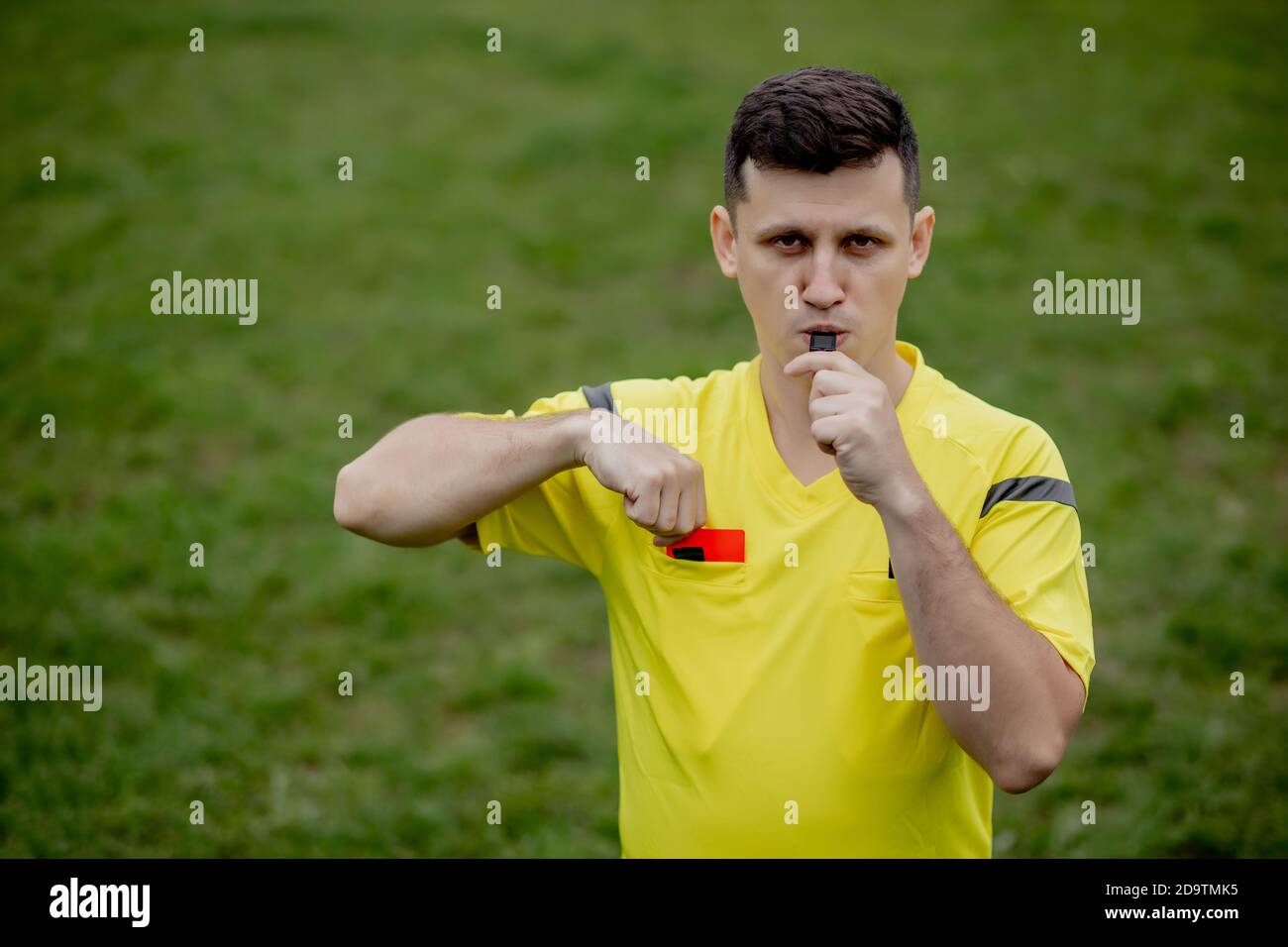 Referee showing a red card to a displeased football or soccer player ...