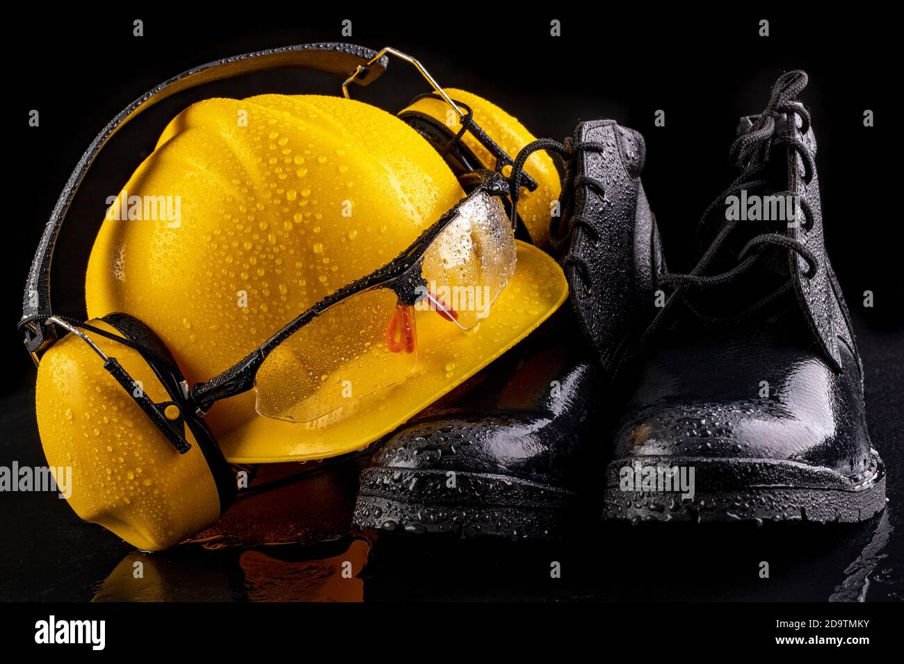 Wet workwear for a production worker. Raindrops on the helmet and ...