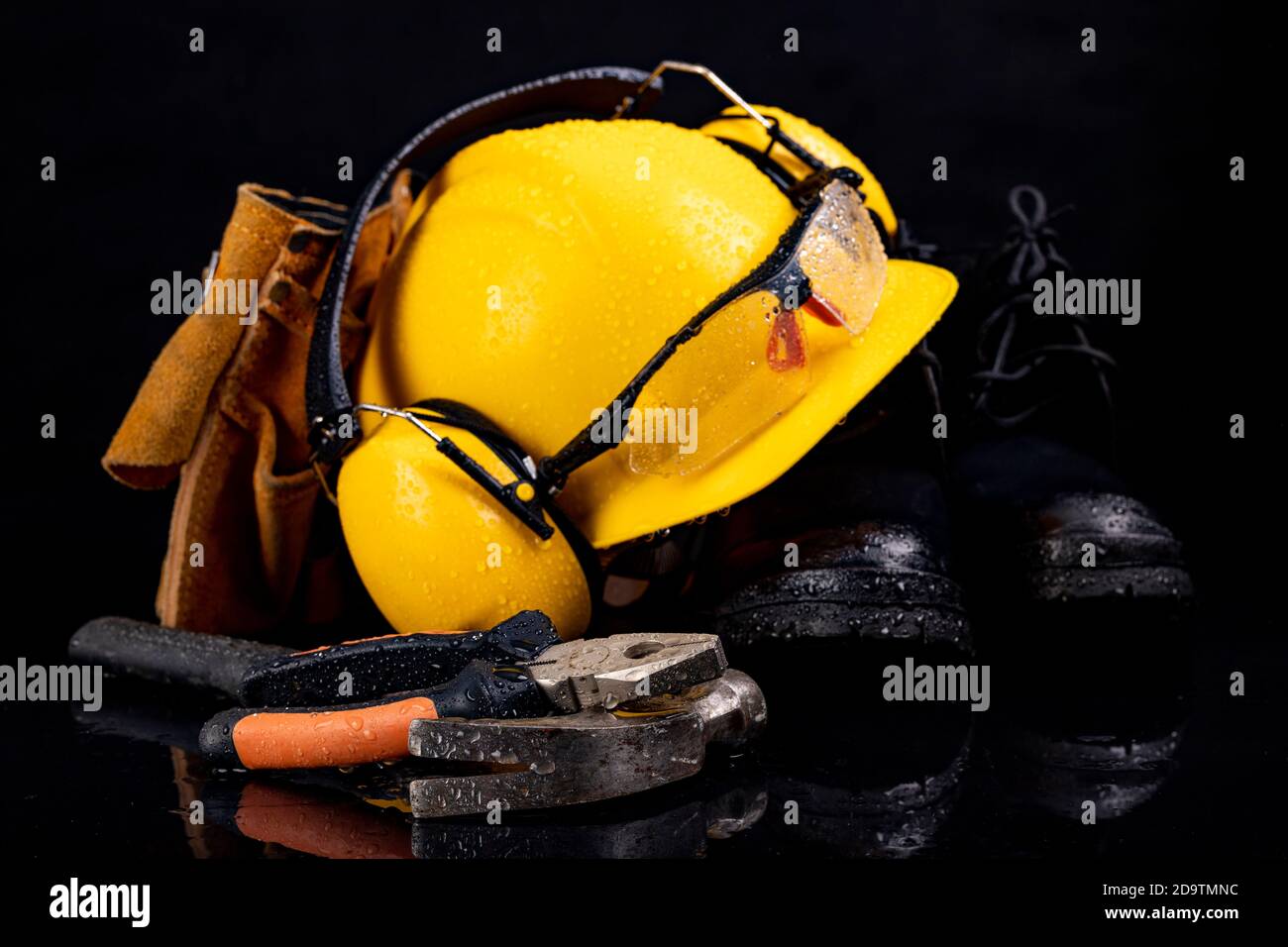 Wet work clothes and tools for the production worker. Raindrops on the ...