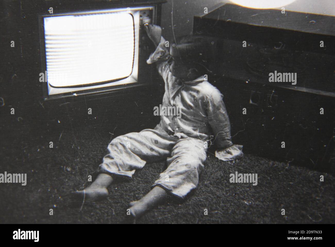 Fine 1970s vintage black and white photography of a young girl watching ...