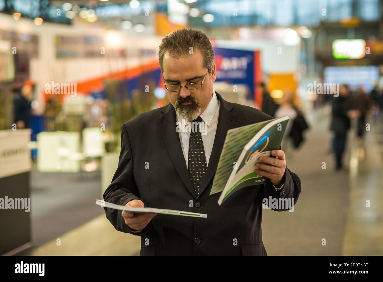 Man reading a report during a convention at the Brno Exhibition Center ...