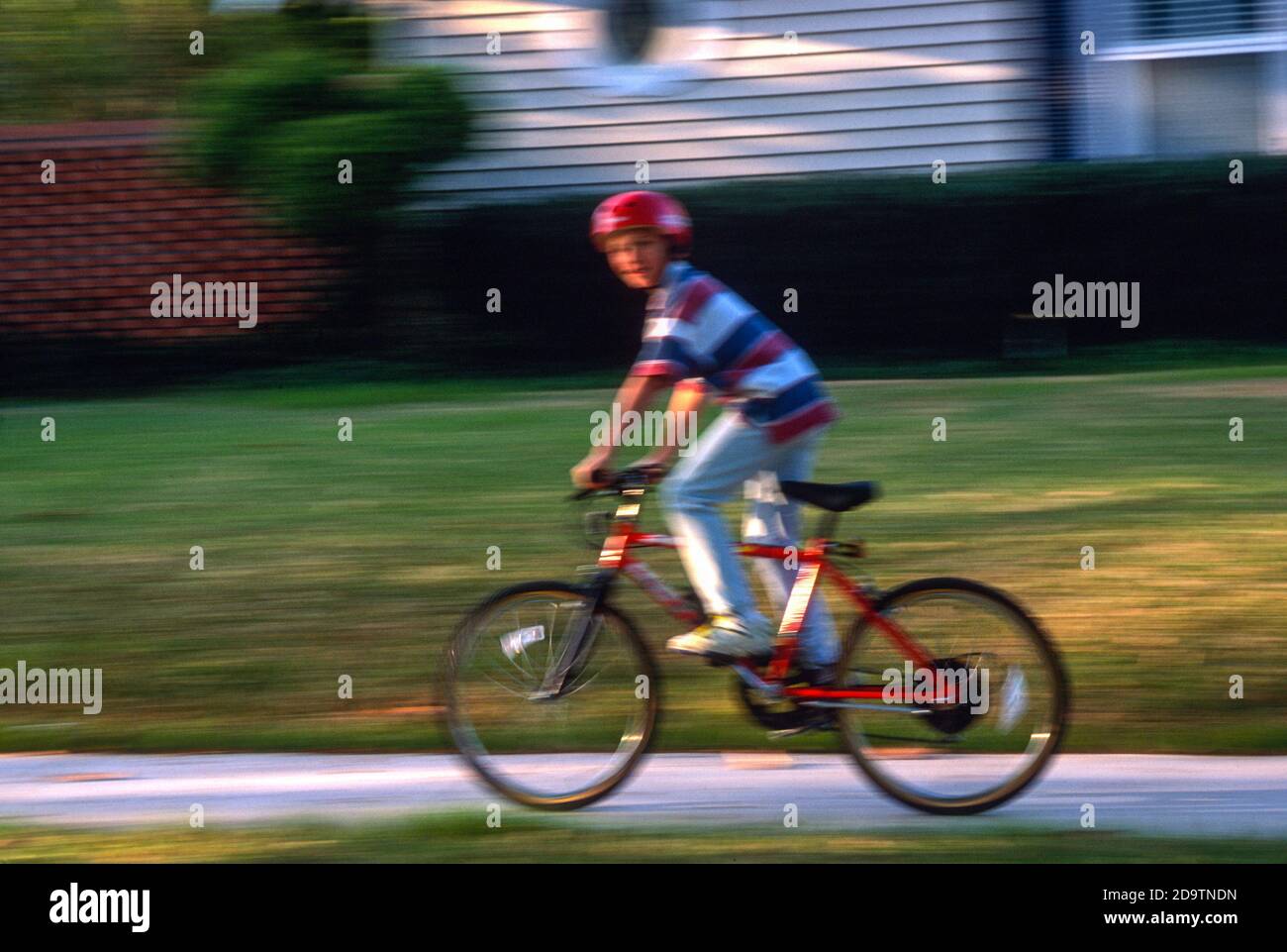 Boy riding bike motion blur hi-res stock photography and images - Alamy