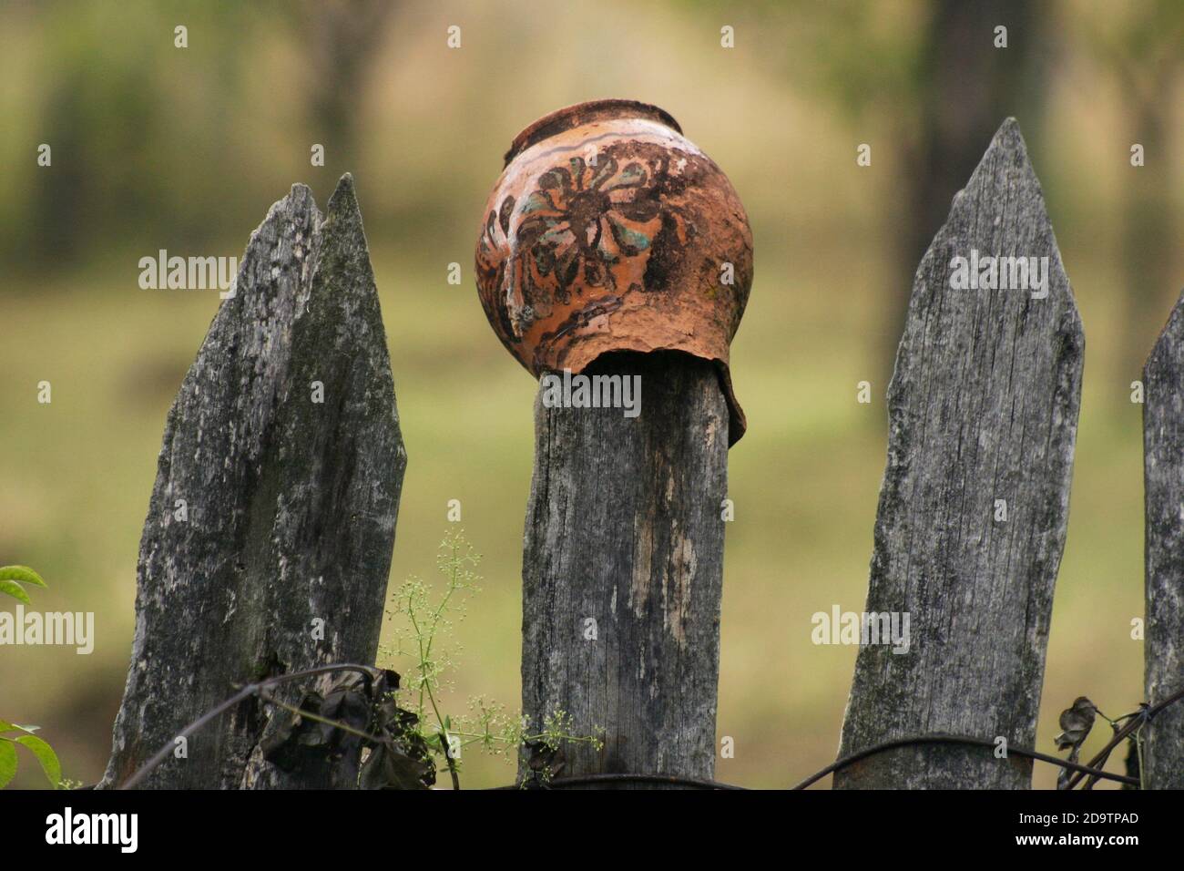 Hateg Country, Romania. A broken jug on an old wooden fence Stock Photo ...