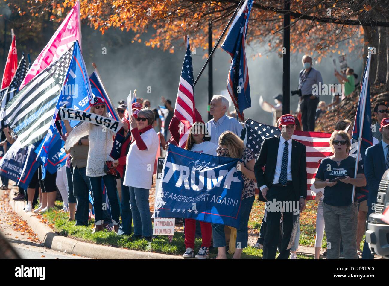 Demonstrators line the street outside the Trump National Golf Club ...