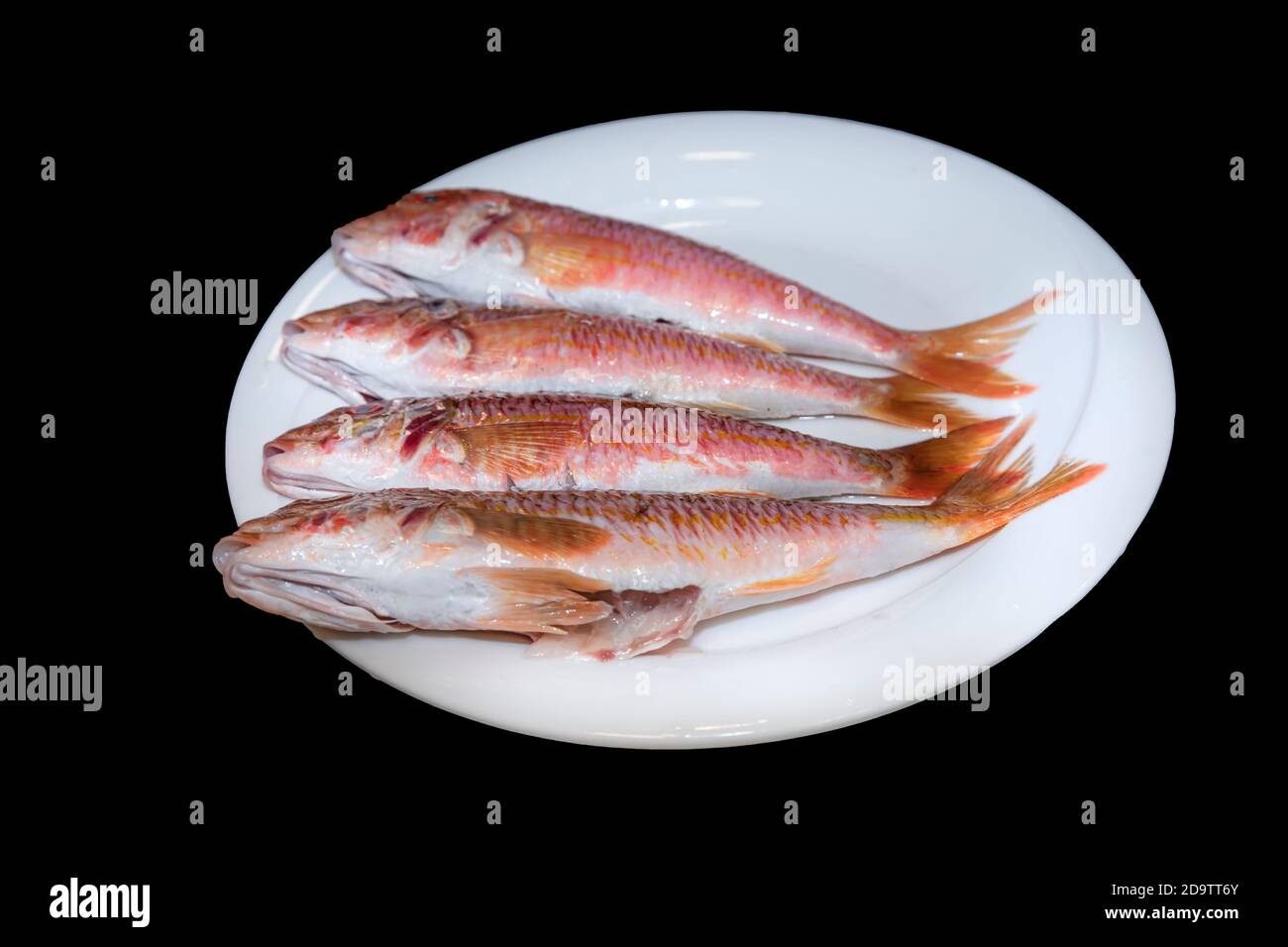 The chef is cleaning the red mullet in the kitchen - preparing it for ...