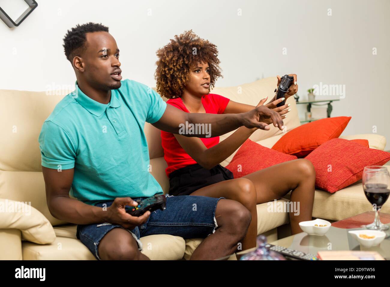 Black African American couple having fun playing video games Stock ...