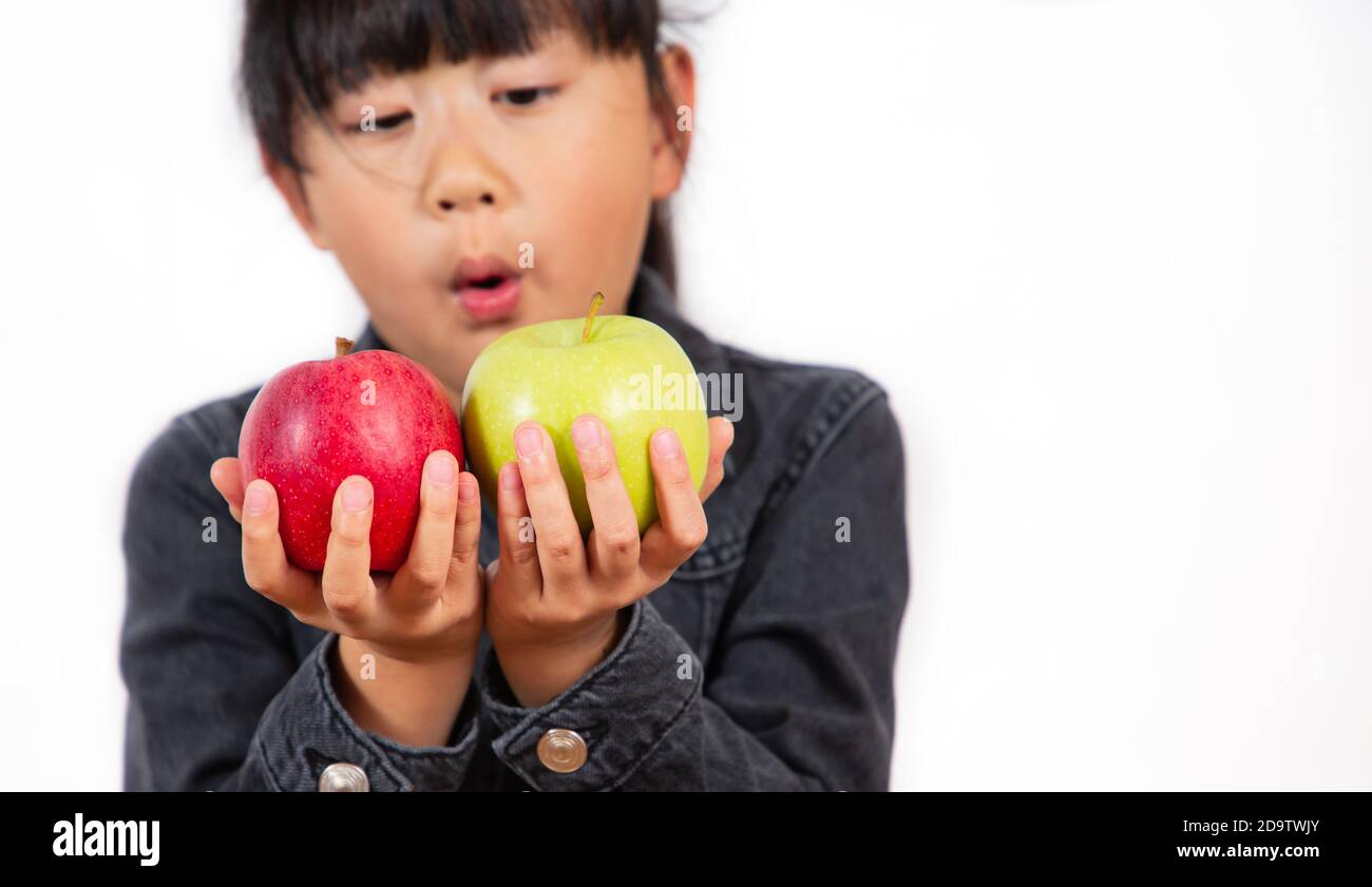 The picture of a child holding a red and green apple in his hand ...