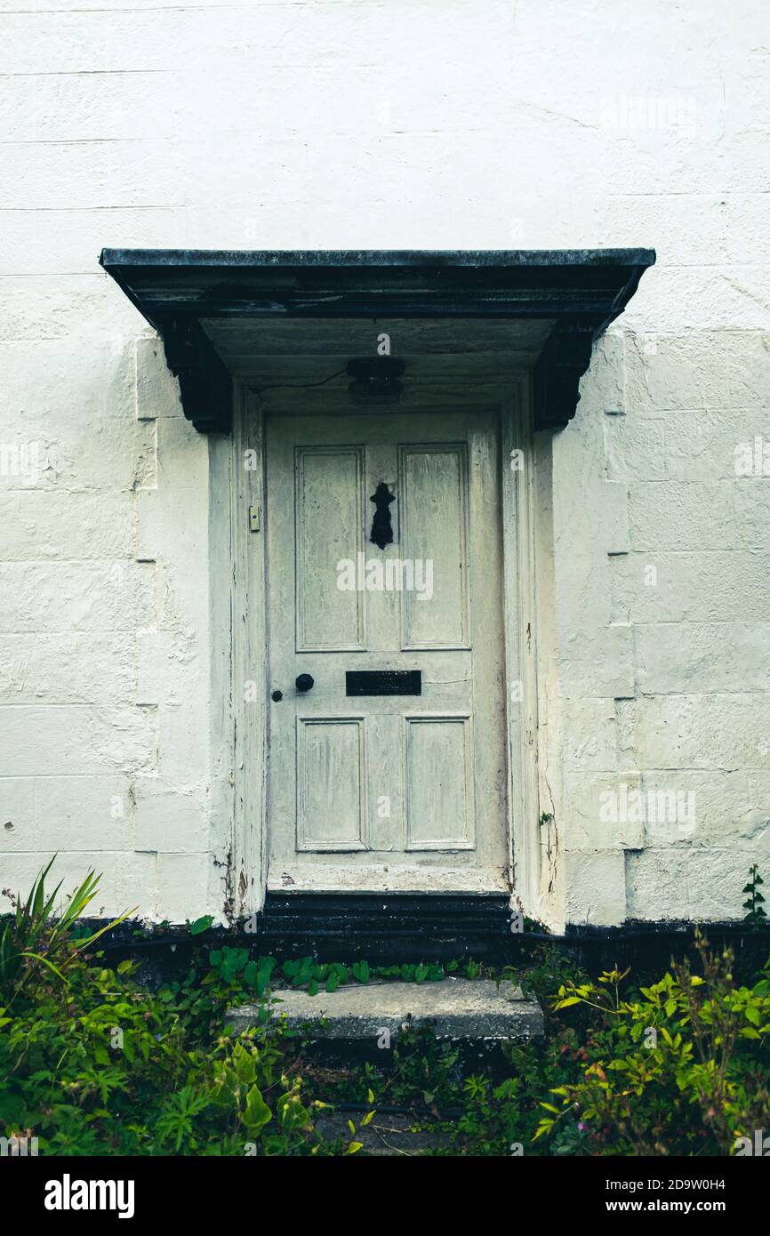Beautiful rural white rustic door with overgrown by weeds stairs ...