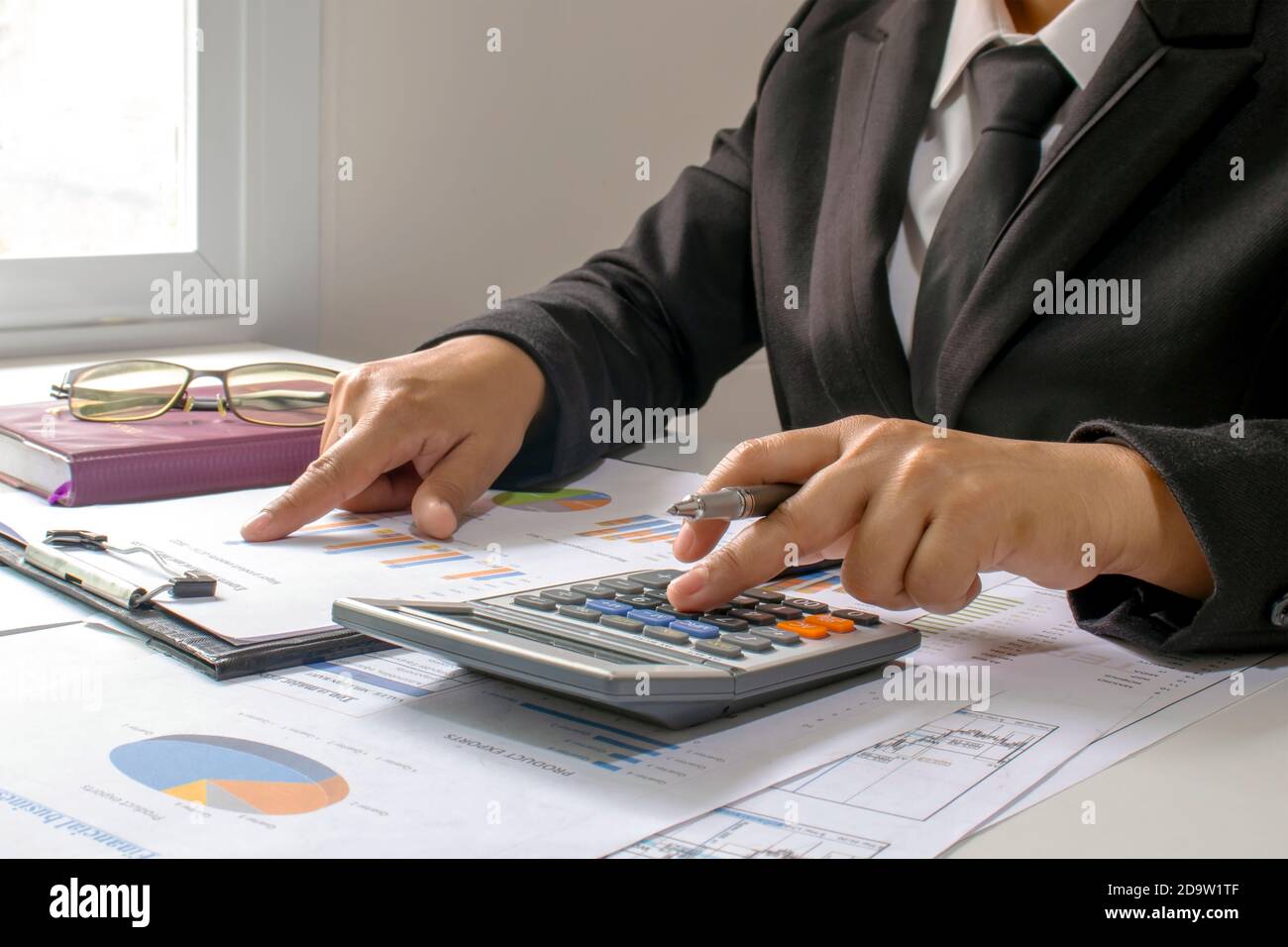 Business people reviewing reports, financial documents for analysis of ...