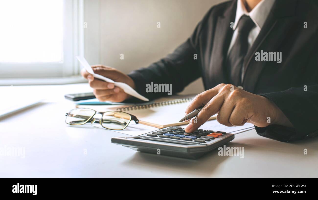 Finance workers are calculating company profits from charts on their ...
