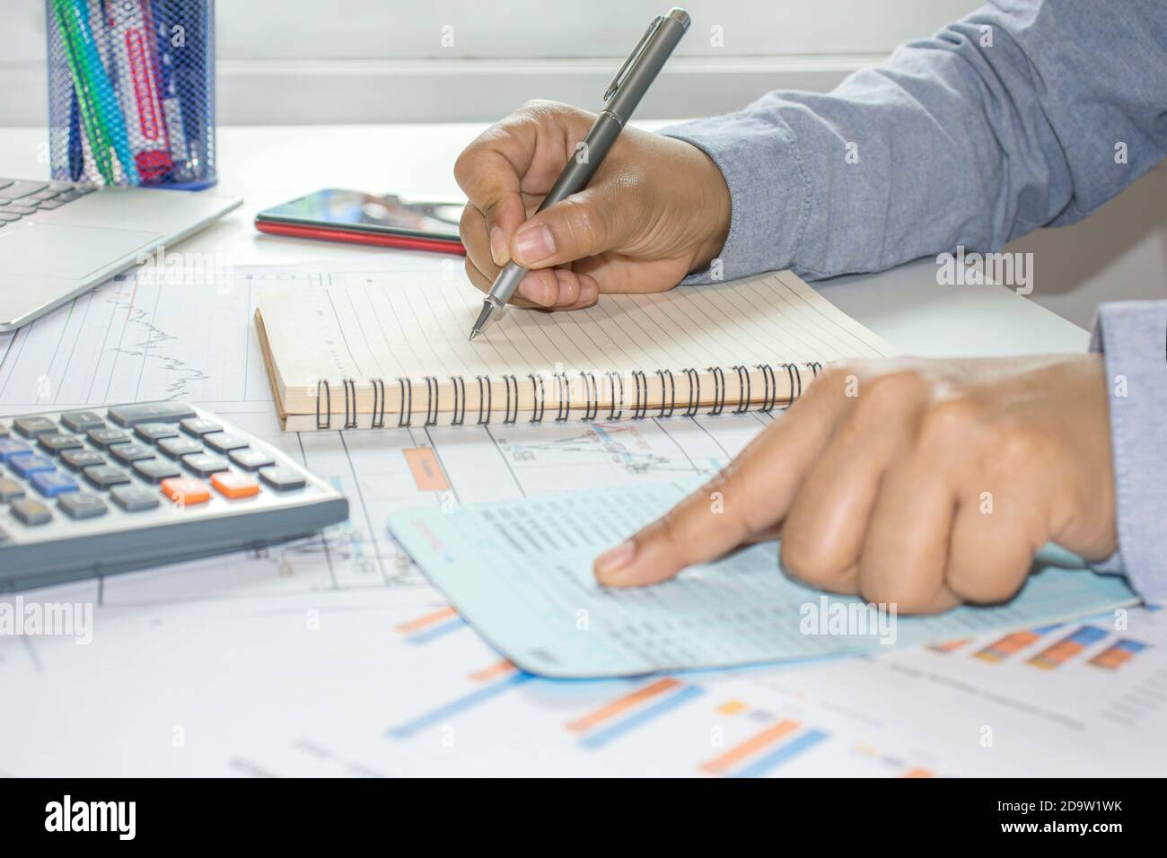 Business people reviewing reports, financial documents for analysis of ...